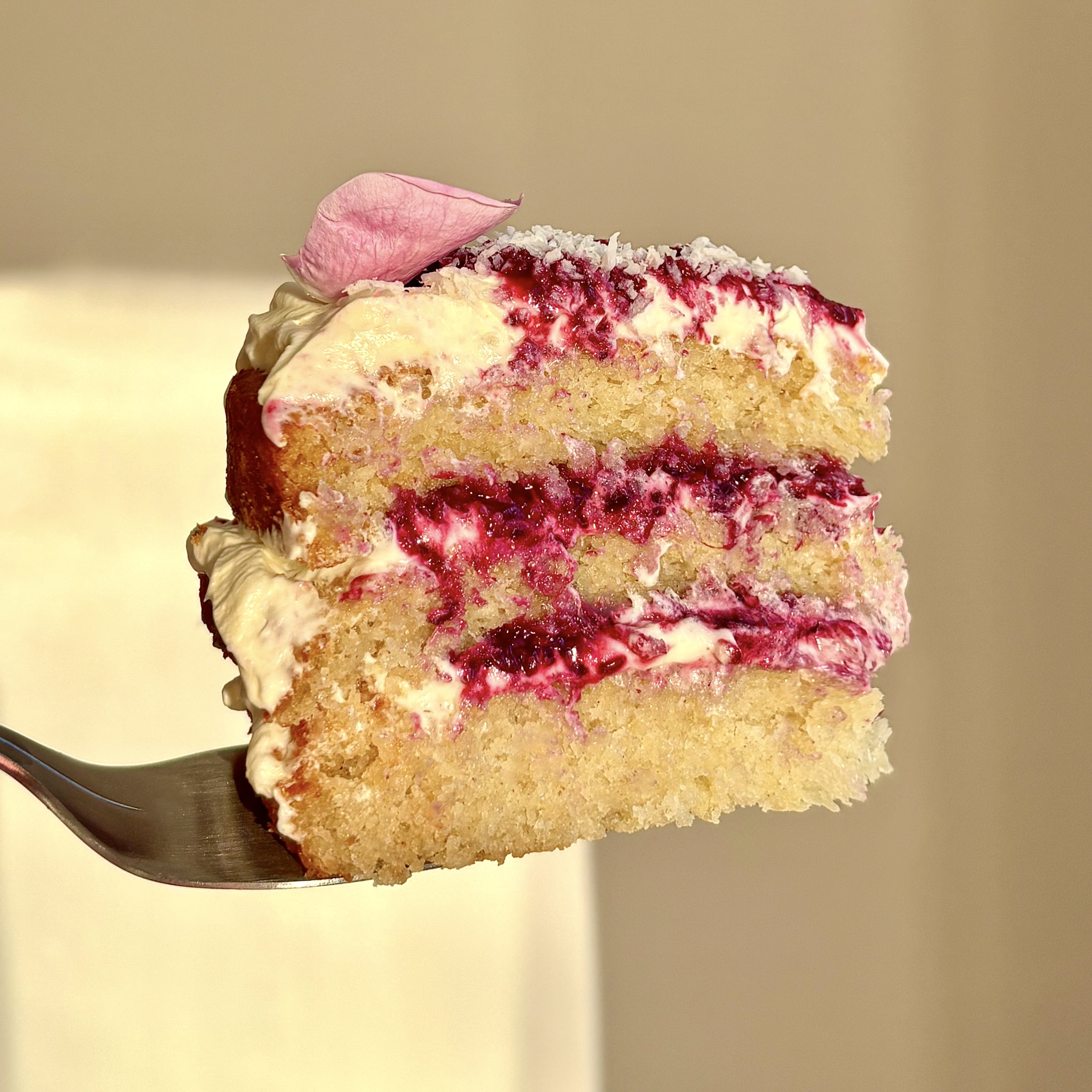 Coconut Sponge, Coconut Cream, Raspberry, Rose and Blackberry Filling.